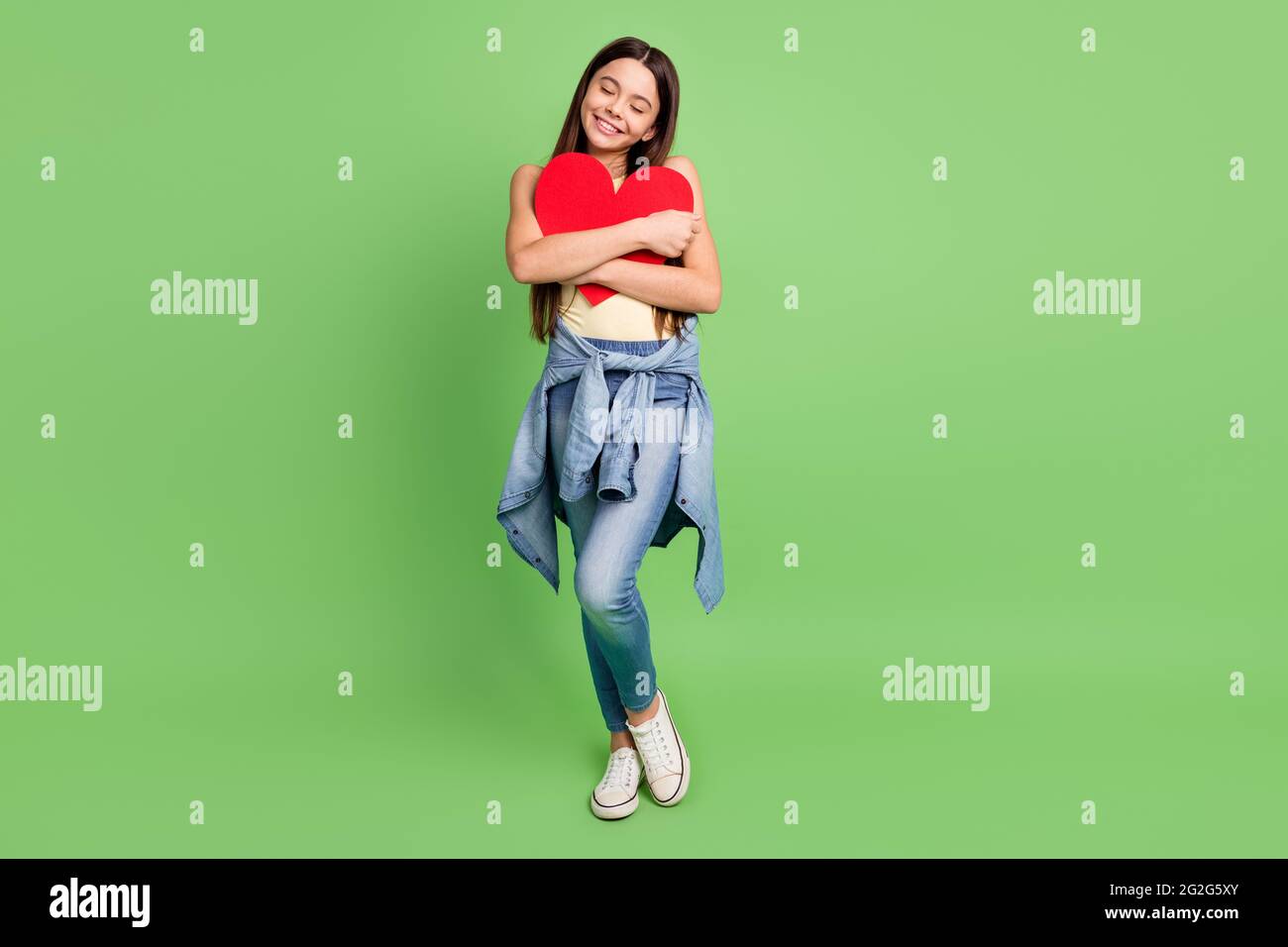 Full size photo of charming girl closed eyes arms hold hugging paper ...