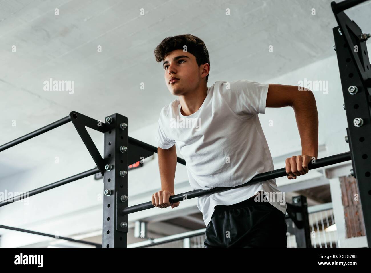 Sporty Man Doing Exercises On A Horizontal Bar Stock Photo - Alamy