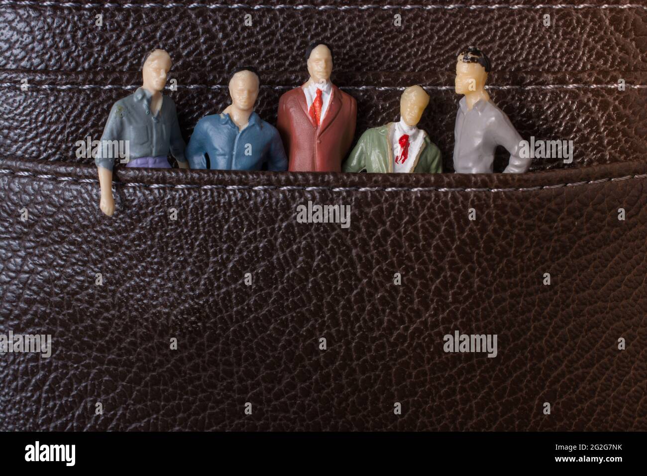 Tiny figurine of men model in pockets Stock Photo - Alamy