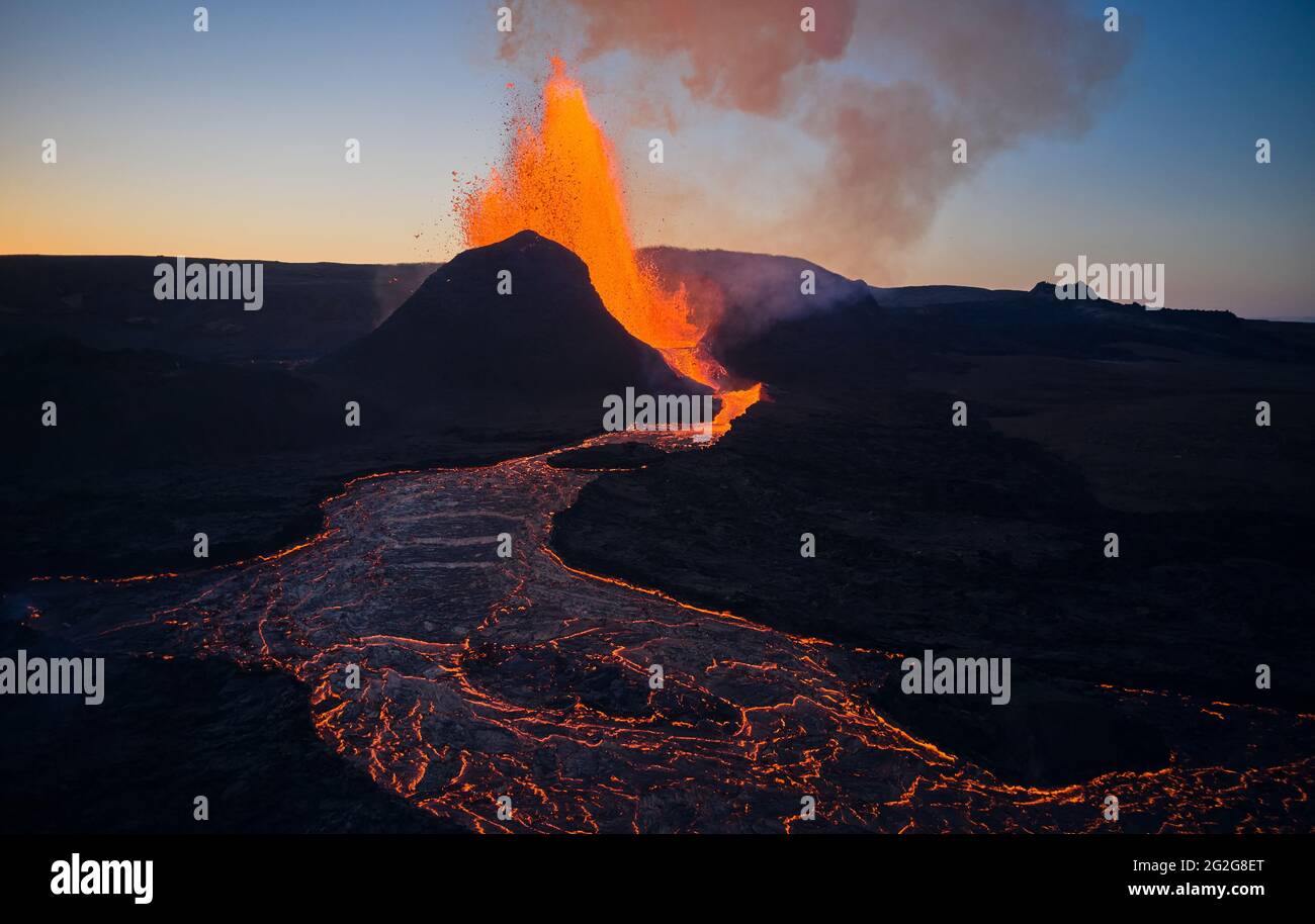 Active volcano erupting at night Stock Photo - Alamy
