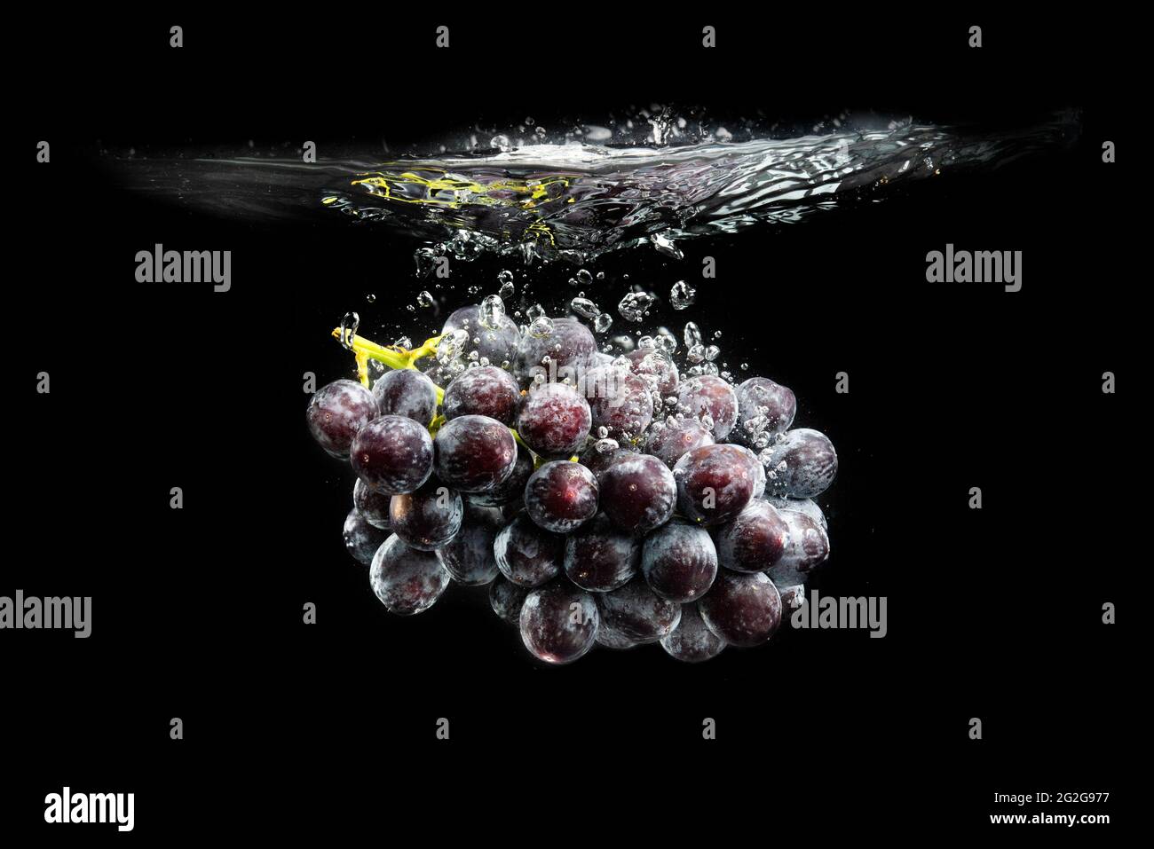 Isolated Red grapes splashing and sinking in water on black Stock Photo ...
