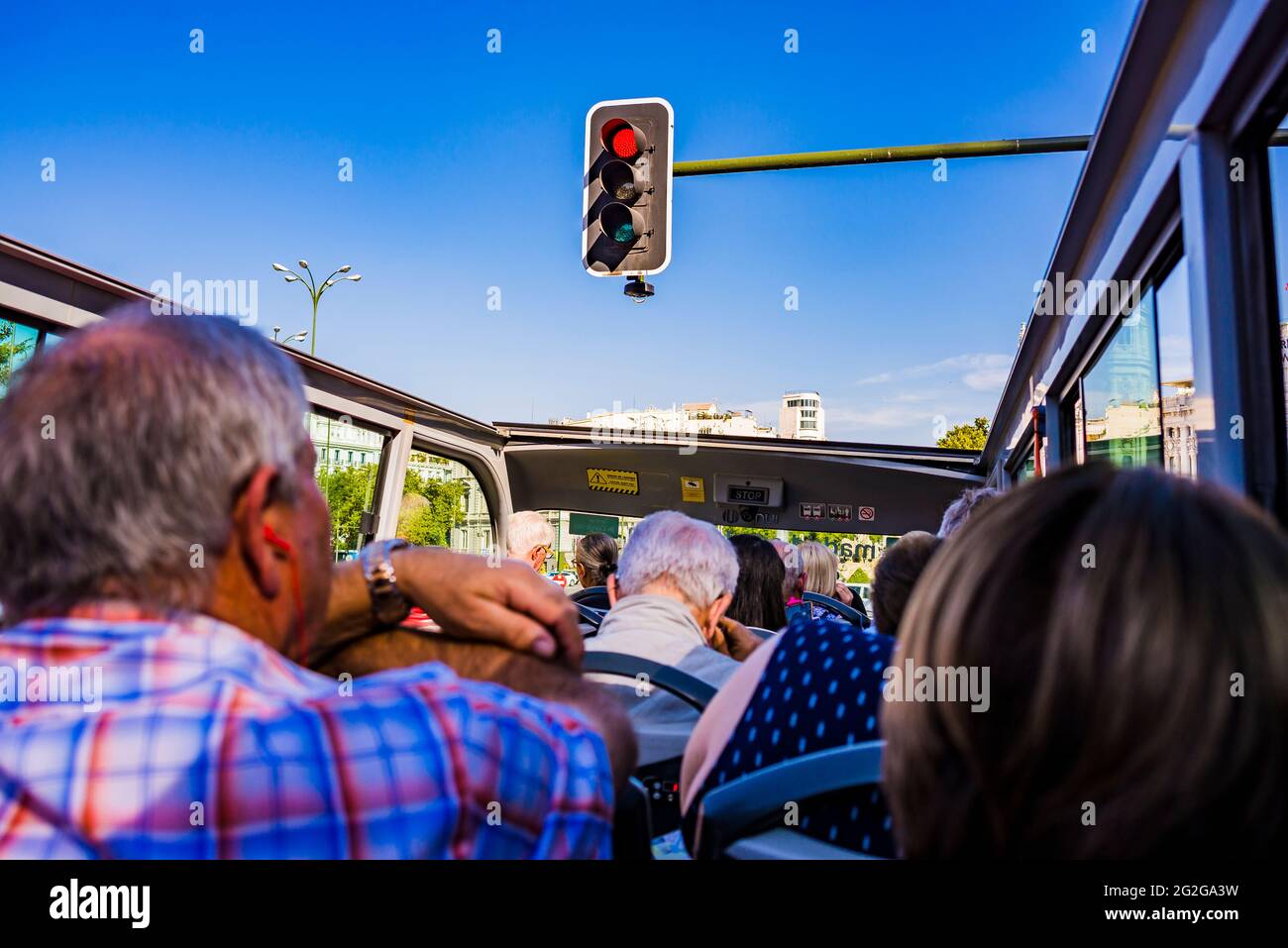 Tourists on the open top desk of the touristic bus standing before a ...