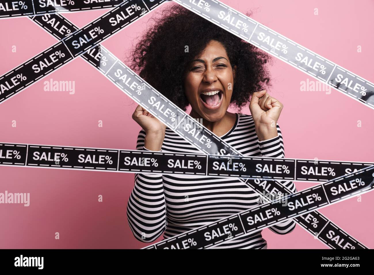 Excited african american girl making winner gesture and screaming ...