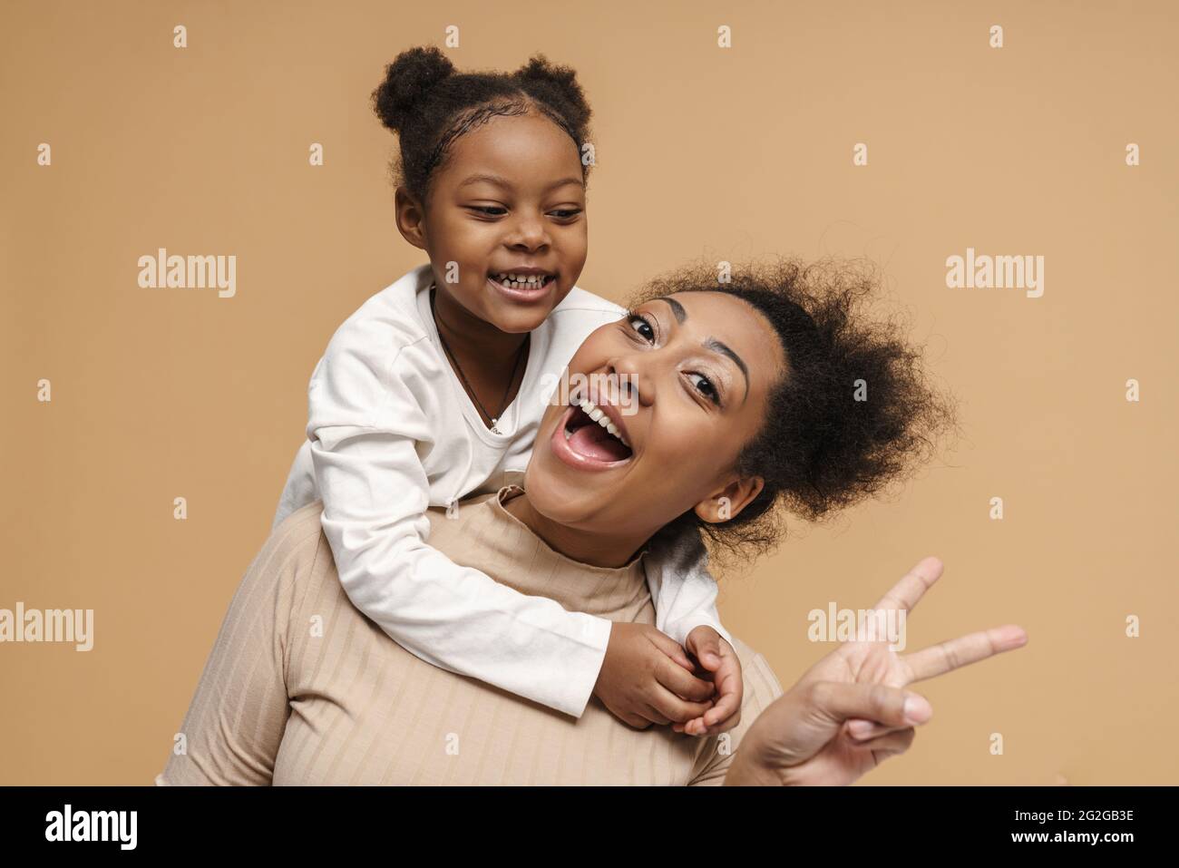 Happy Black Mother And Daughter Laughing While Showing Peace Sign