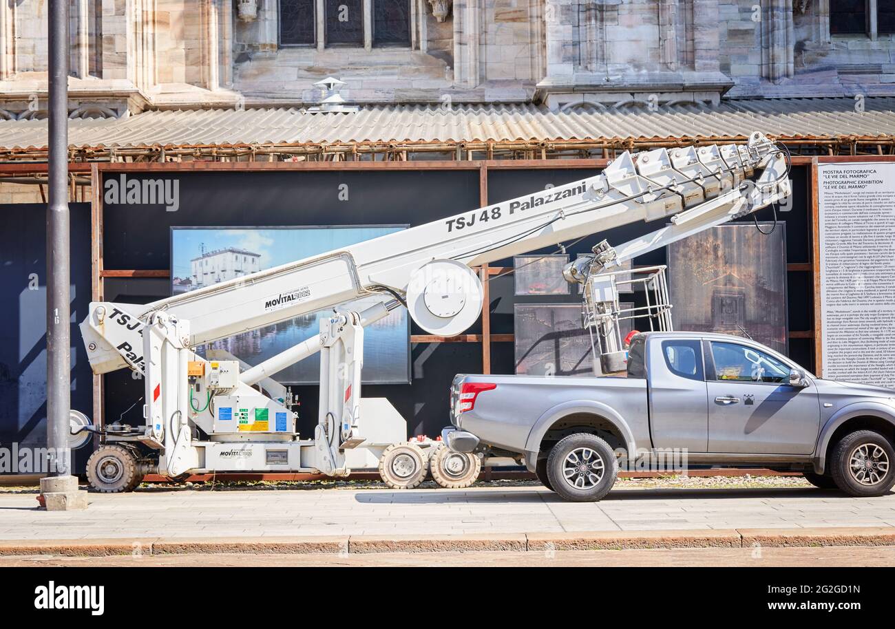 Milan, Italy - July 7, 2020. Car and scissor lift platform with ...