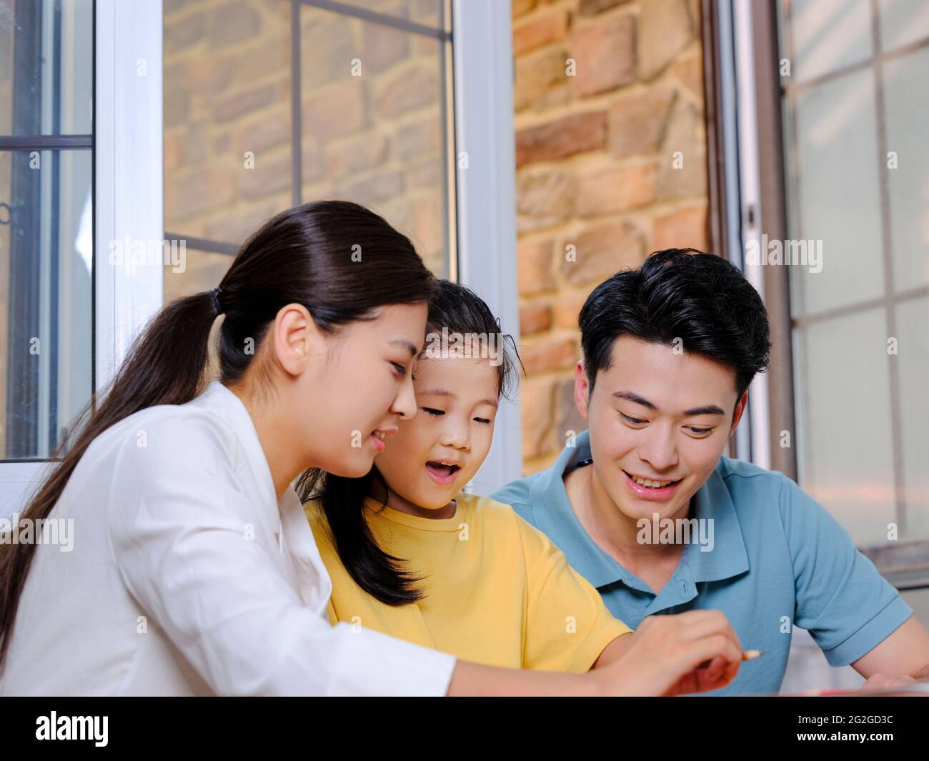 Young parents help their children with their homework high quality ...