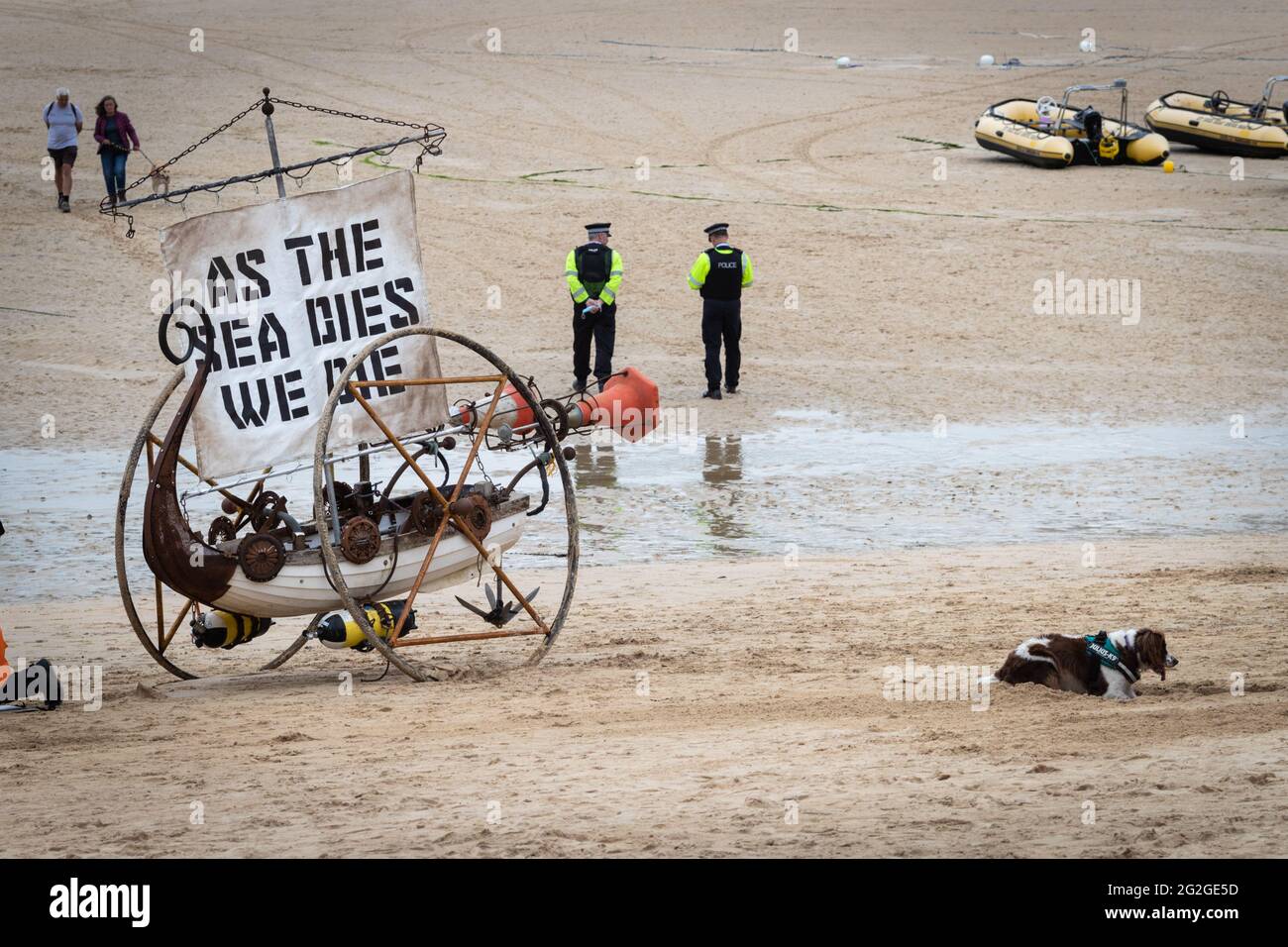 St Ives, UK. 11th June, 2021. The police walk across St Ives beach ...