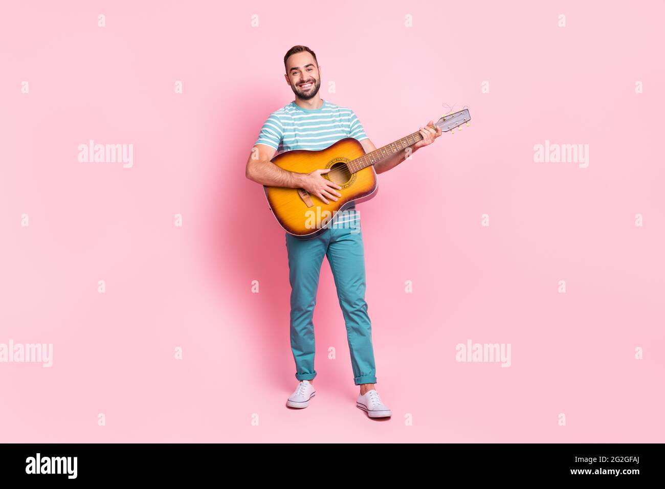 Full length body size view of attractive cheerful guy playing string ...