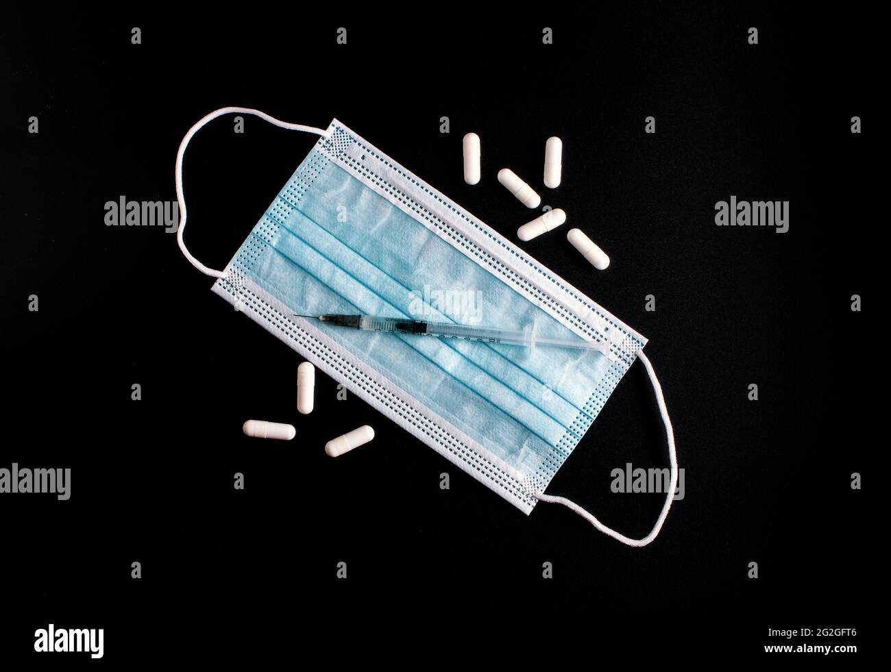 Blue medical face mask with an insulin syringe. Balus white medicine ...