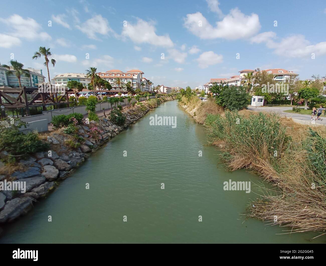 Green canal flowing through a town Stock Photo - Alamy