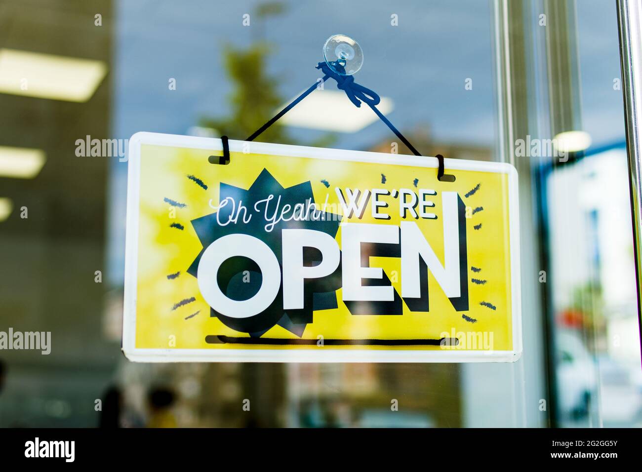Selective focus of signage with a text We're Open through the glass ...