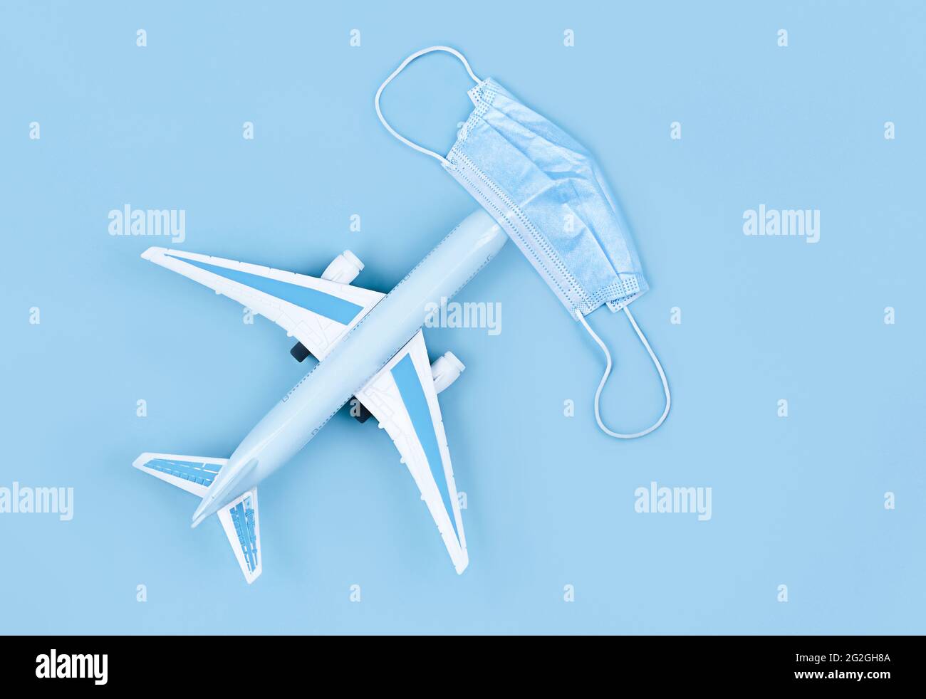 Airplane in flight with a medical mask. Concept - observance of safety ...