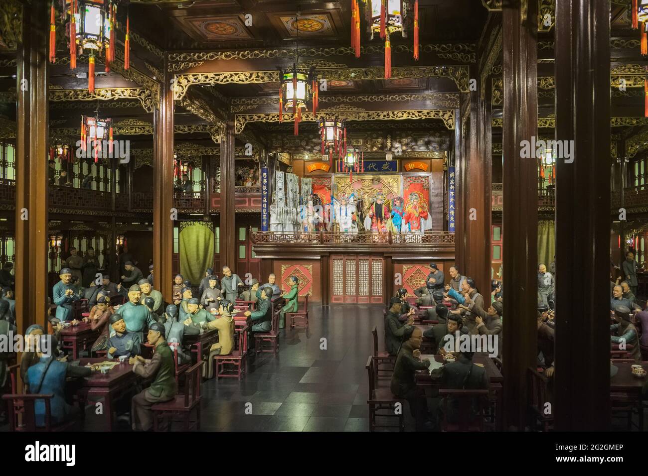 A replica of an ancient Chinese restaurant with figurines of people ...