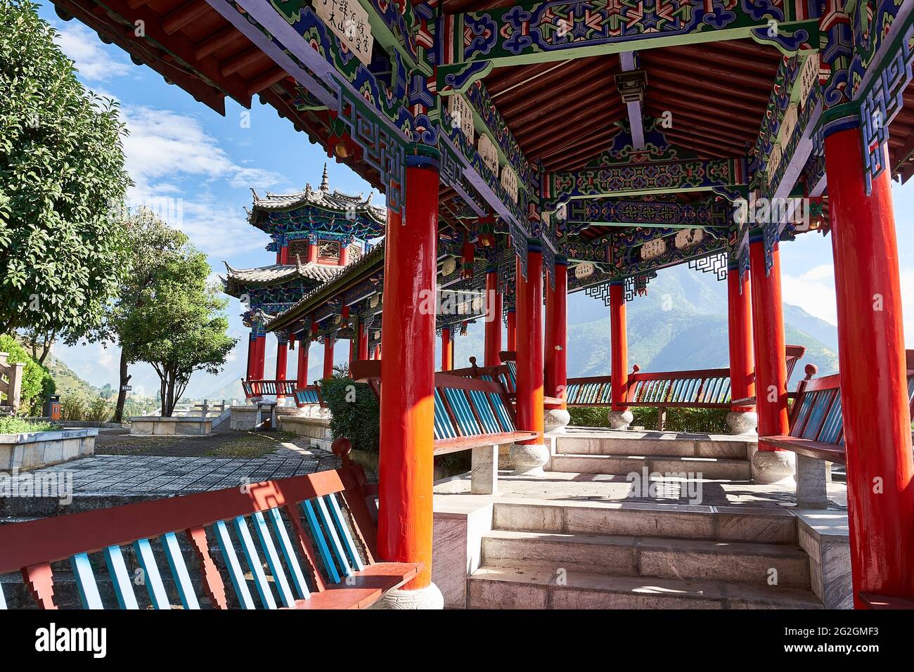 A red and blue coloured Chinese design style covered walkway with rest ...
