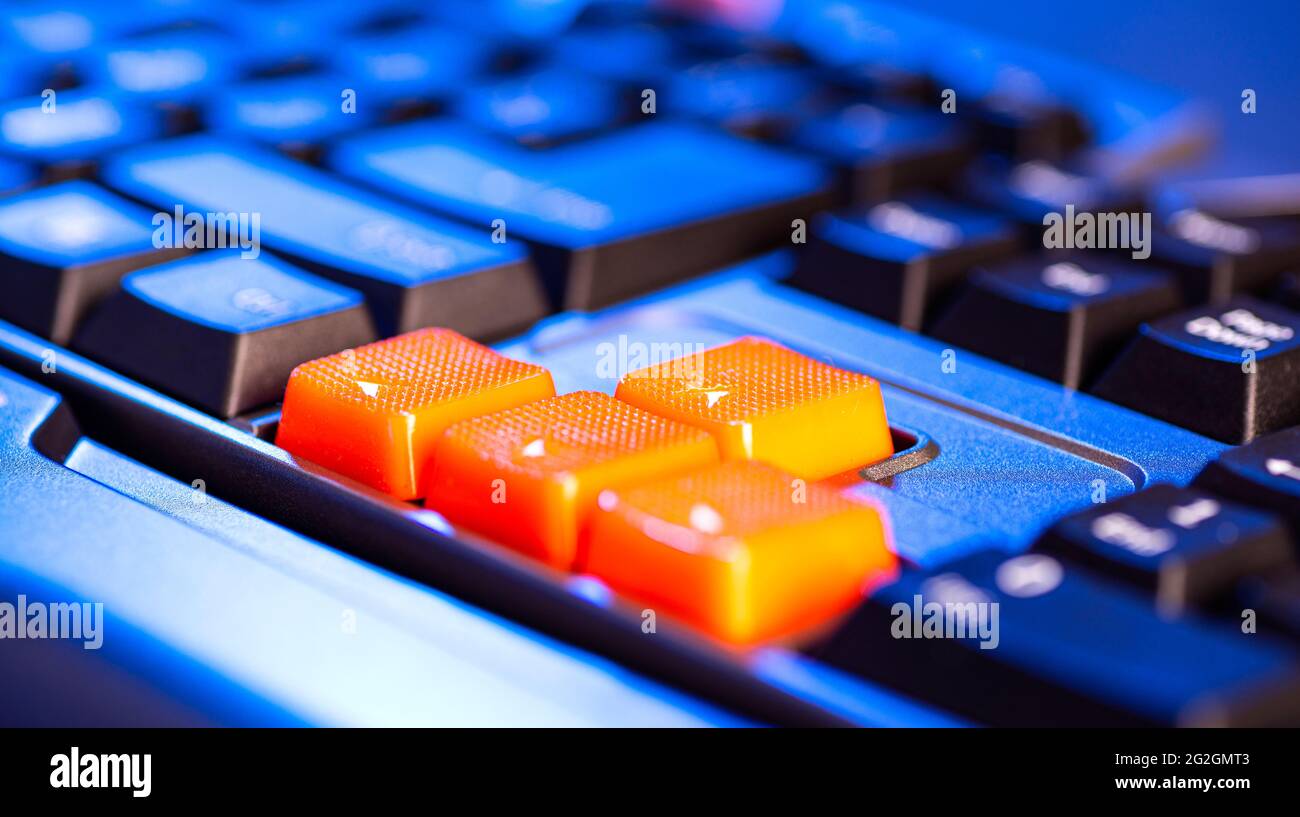 Close-up of orange arrow keys on a black keyboard, up, down, left ...