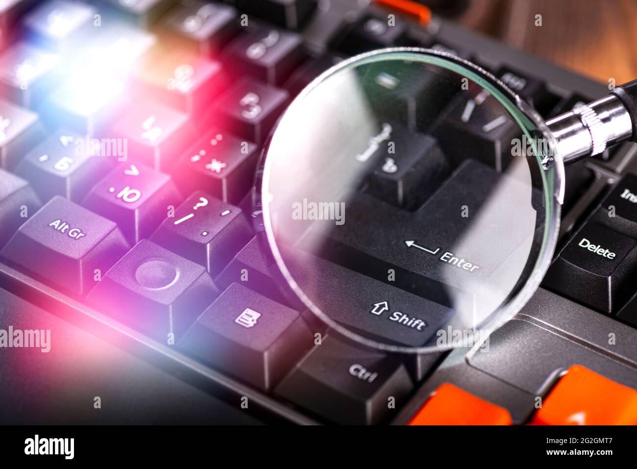 Closeup images of magnifying glass on laptop keyboard Stock Photo - Alamy