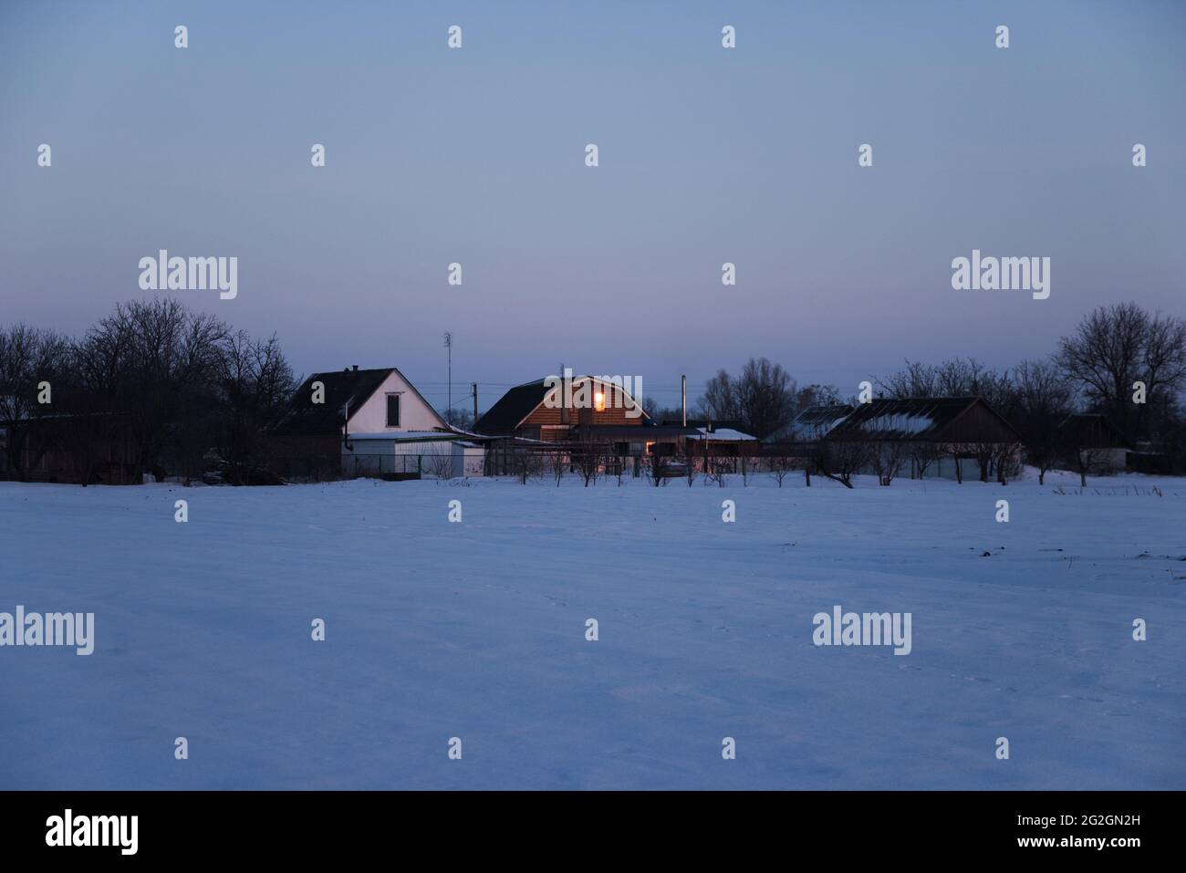 Night landscape of a snow-covered field. In the distance is seen the ...