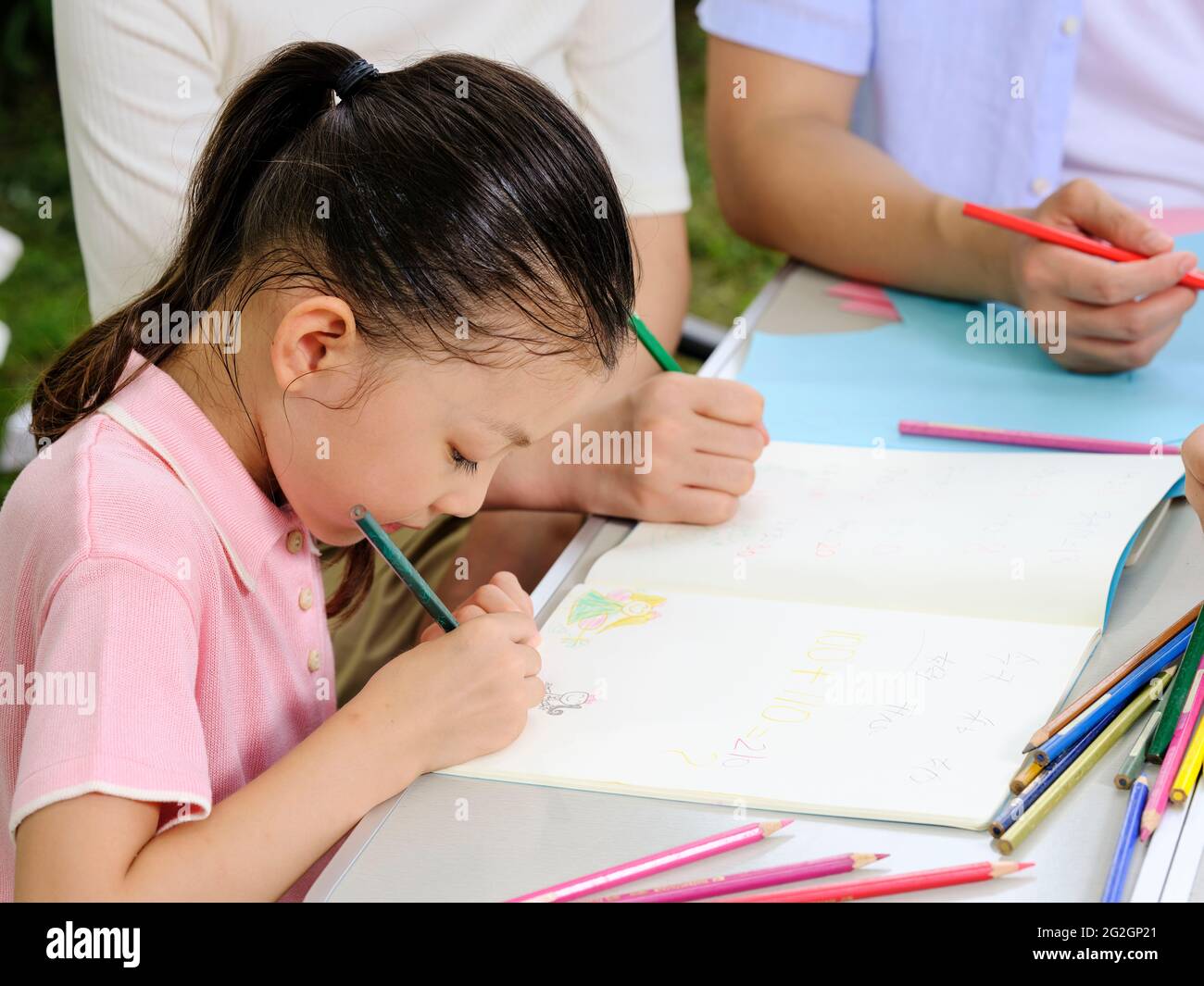 Young parents help their children with their homework outdoors high quality photo Stock Photo ...