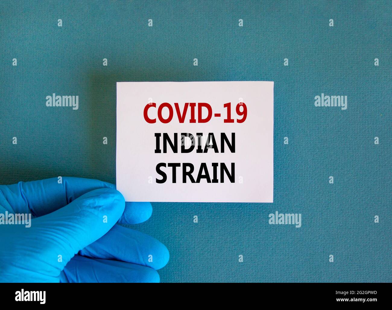 New covid-19 indian variant strain symbol. Hand in blue glove with ...
