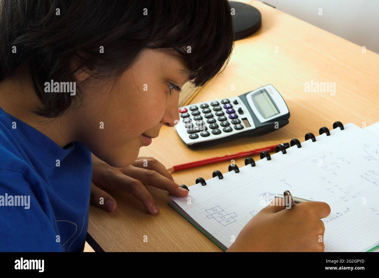 Boy doing math exercises at his desk Stock Photo - Alamy