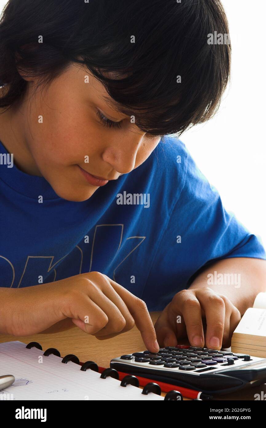 Boy using a calculator Stock Photo - Alamy