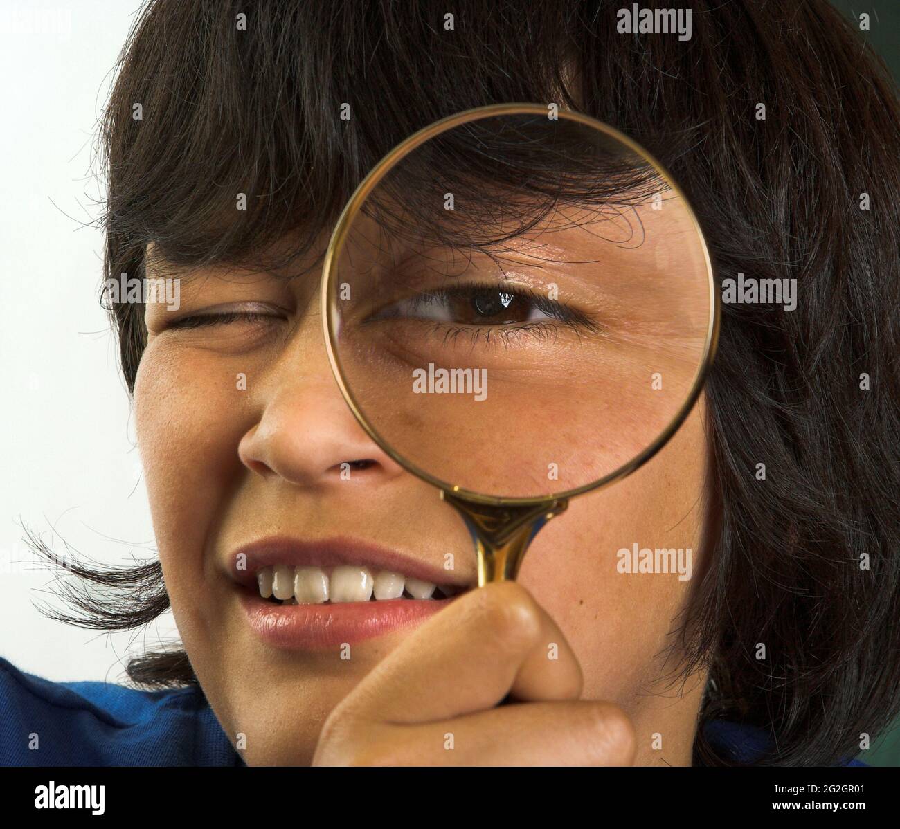 Boy using a magnifier Stock Photo - Alamy