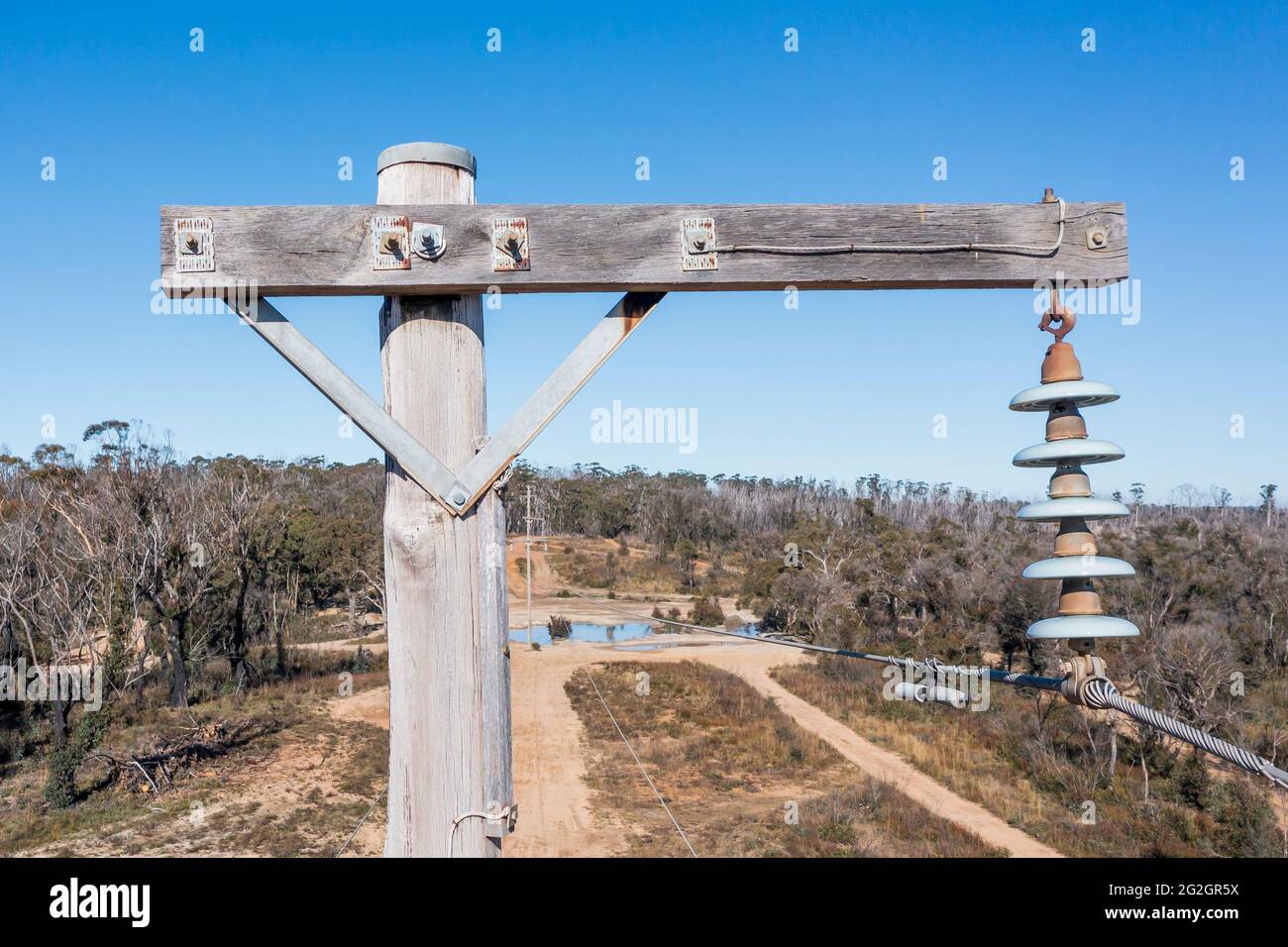Drone aerial photograph of a telephone pole and wires in a forest ...