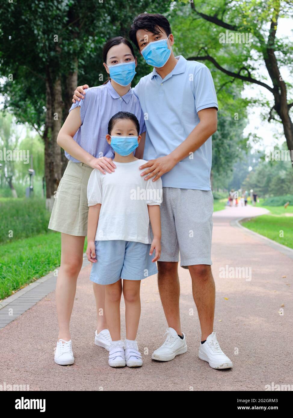 A family of three with masks high quality photo Stock Photo - Alamy