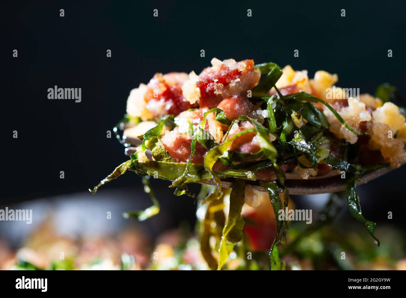 eating tropeiro beans, Brazilian dish Stock Photo - Alamy