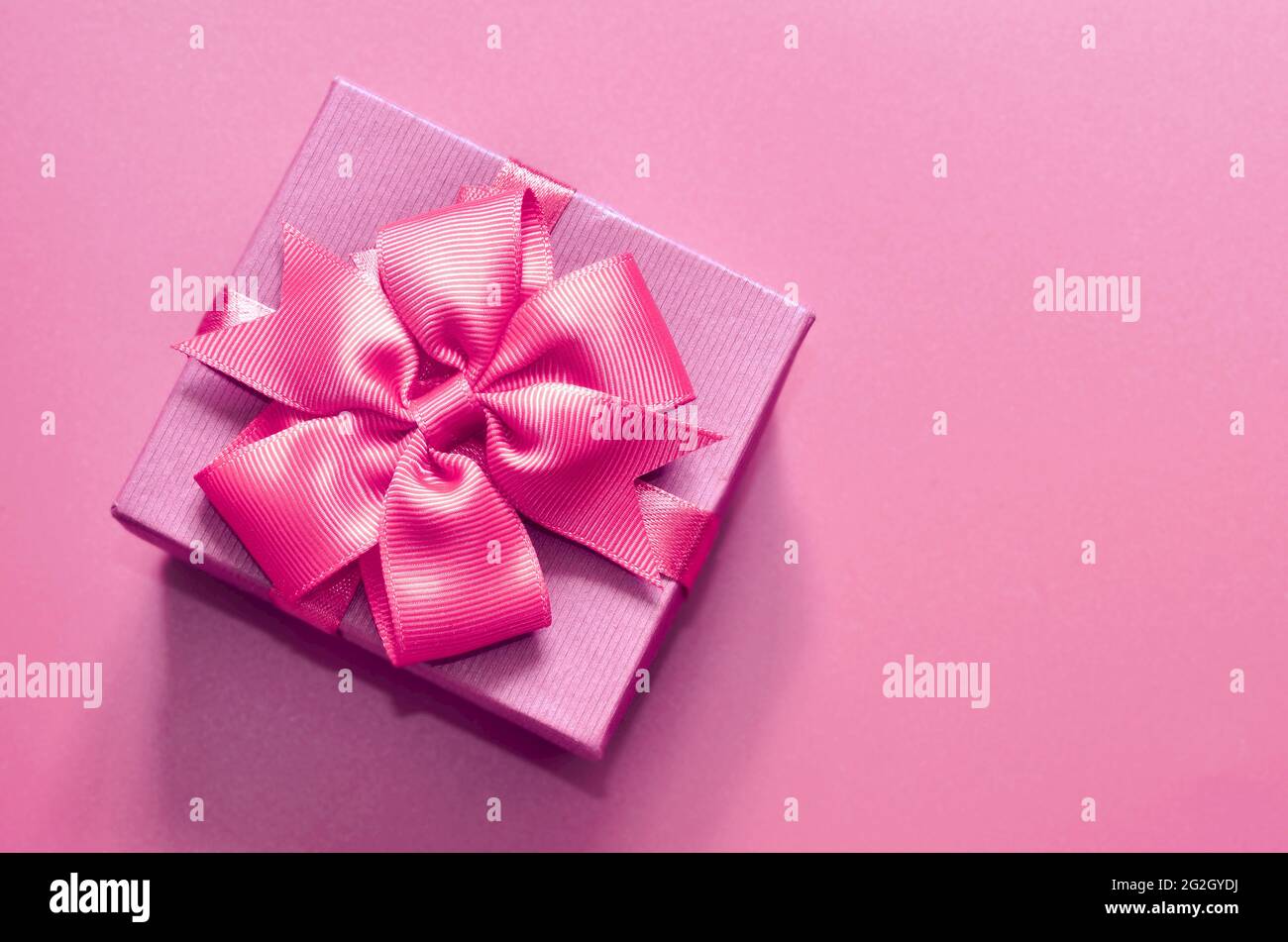 Holiday concept banner with hand made gift box, bow on a purple ...
