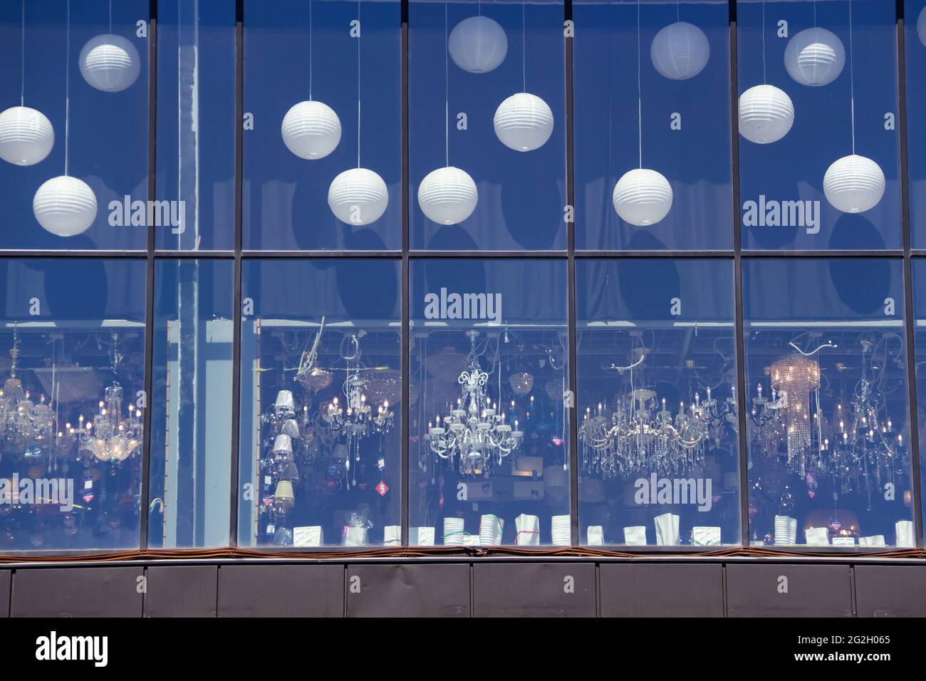 Shop lighting showcase with chandeliers. Street view of the window. An ...