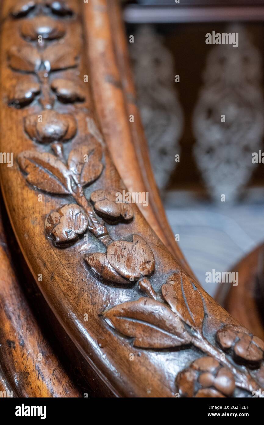 Close up photograph showing detail on the carved wooden handrail of the ...