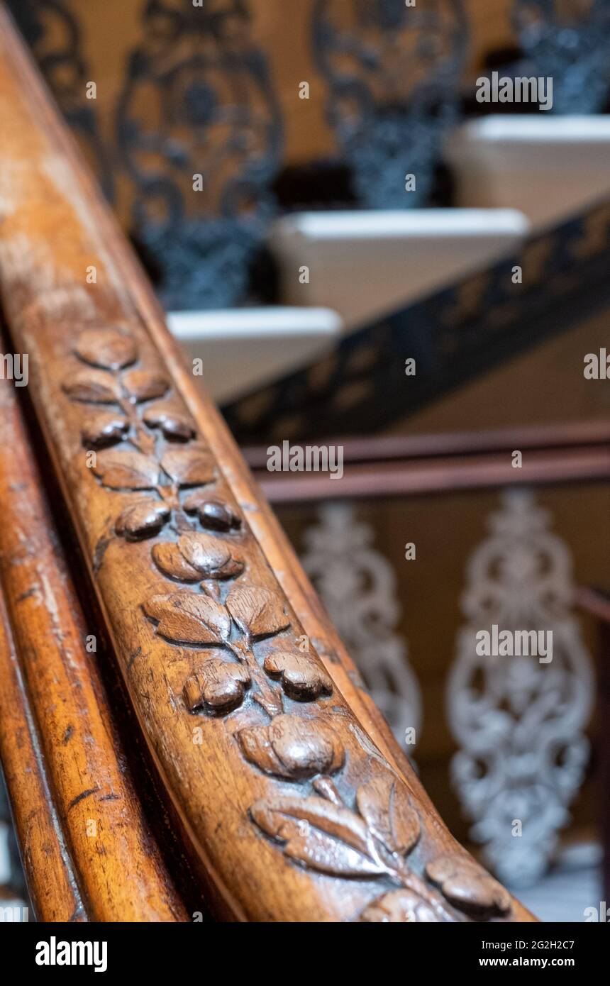 Close up photograph showing detail on the carved wooden handrail of the ...