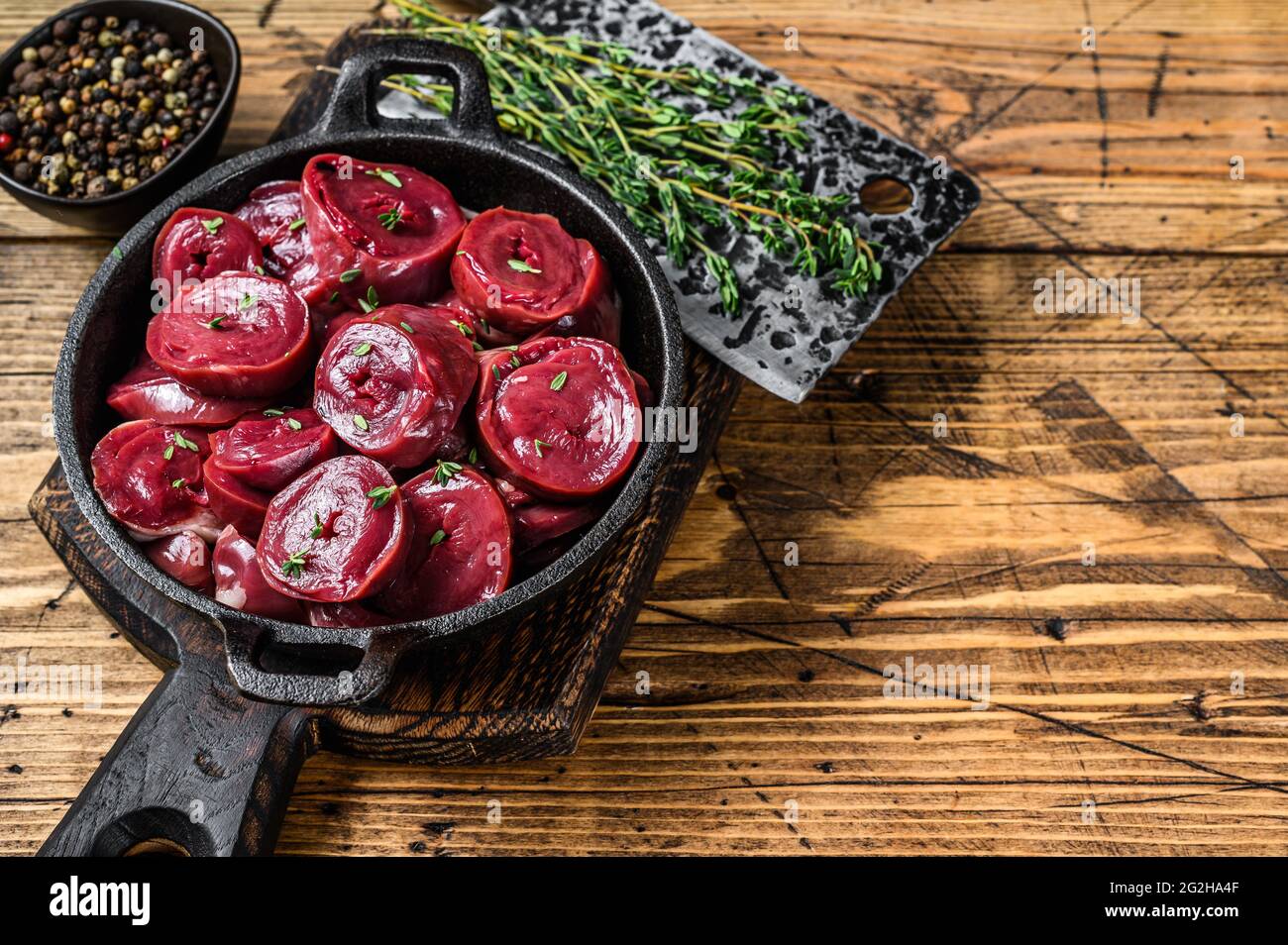 Sliced Raw turkey hearts offal in a pan. wooden background. Top view ...