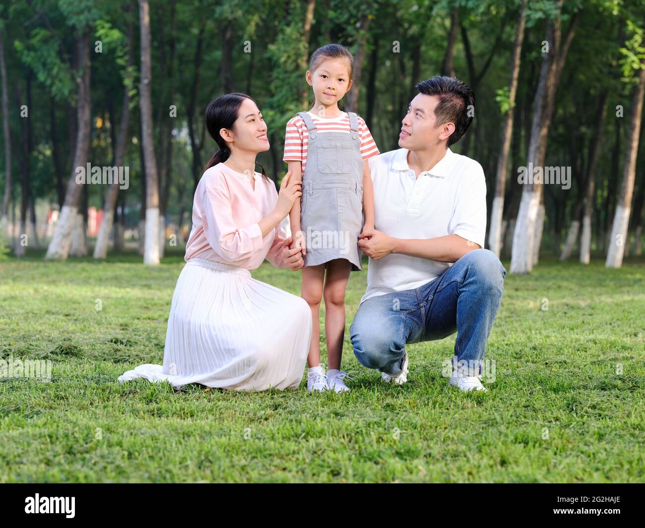 Happy family of three playing in the park high quality photo Stock ...