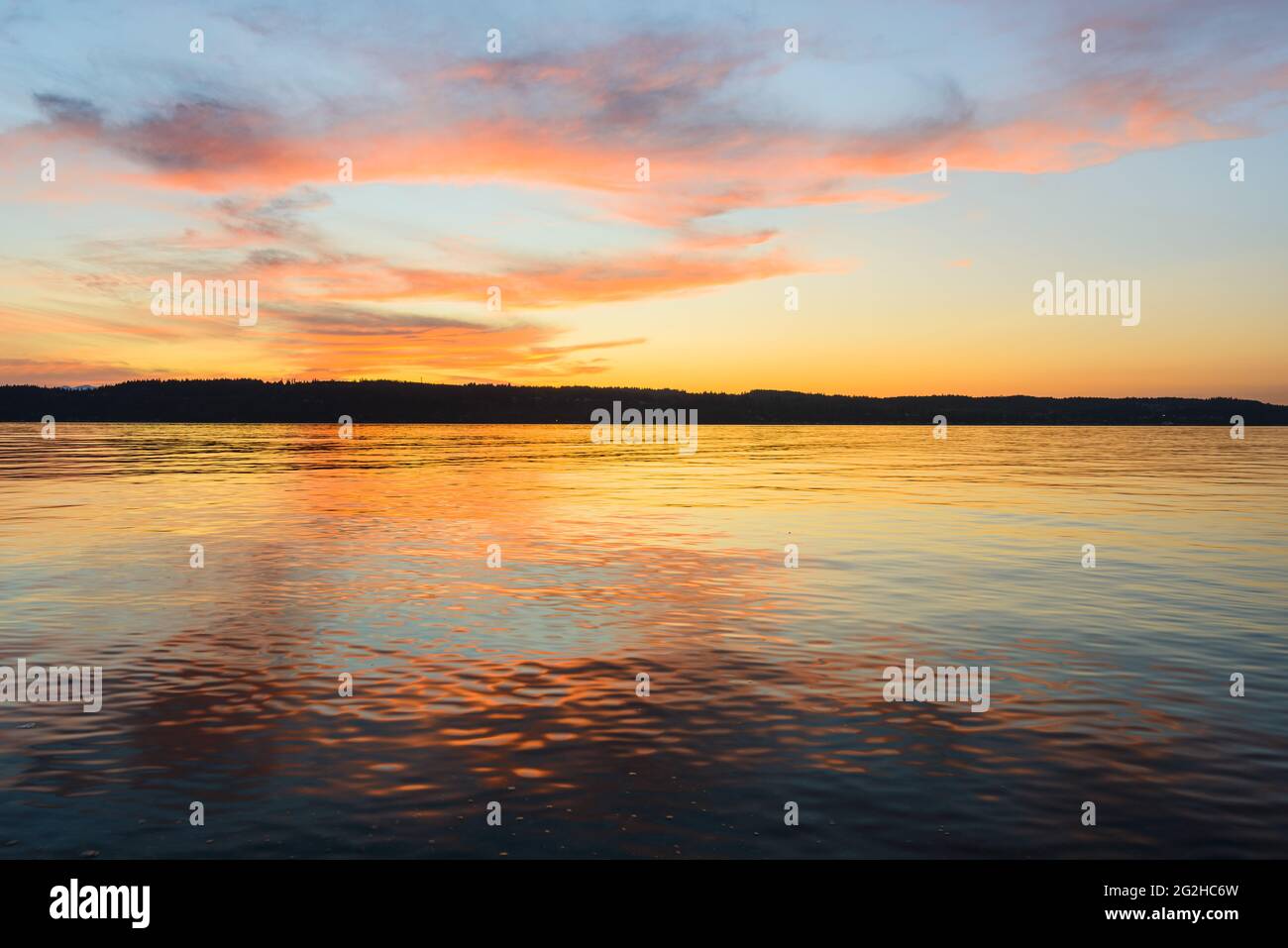 The sun sets over Puget Sound in western Washington State creating a ...