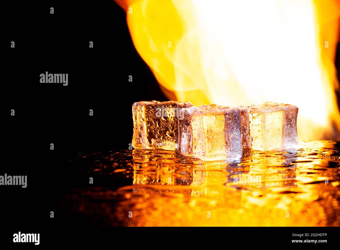 three ice cubes against the background of fire, fire and ice, place ...