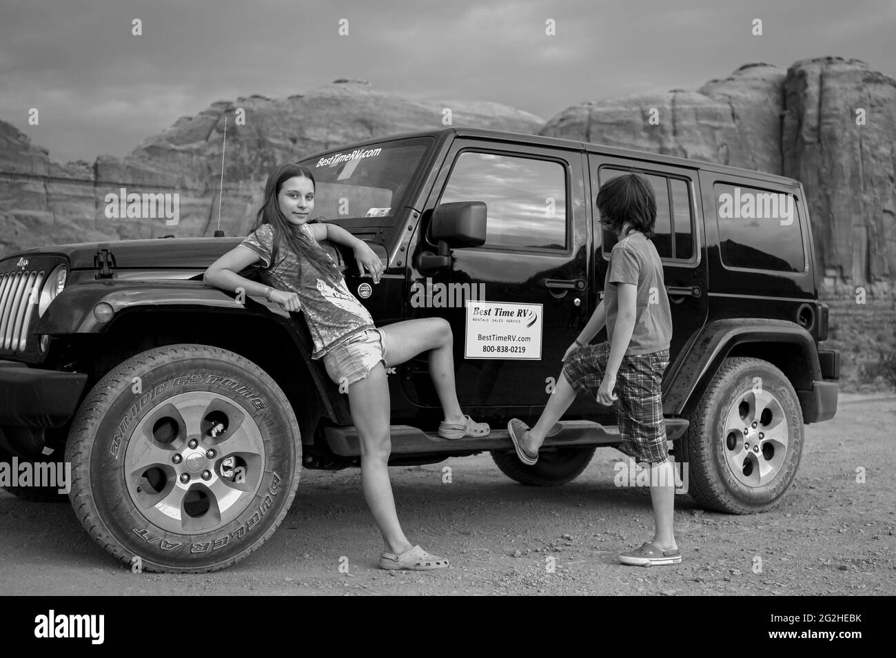 A girl and a boy in front of a Jeep Wrangler and a classic view of ...