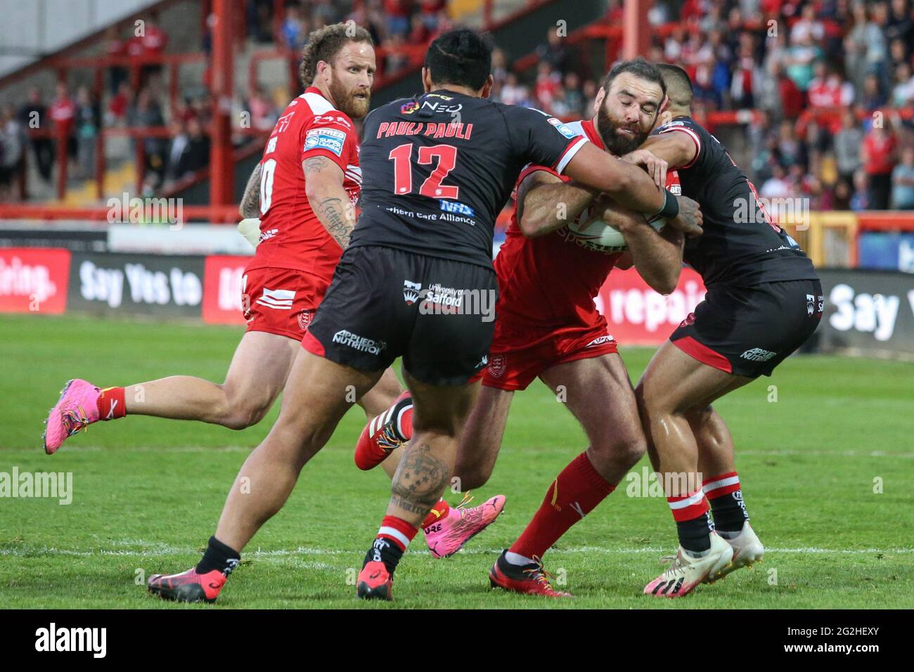 Kane Linnett (12) of Hull KR runs at the Salford defence Stock Photo ...