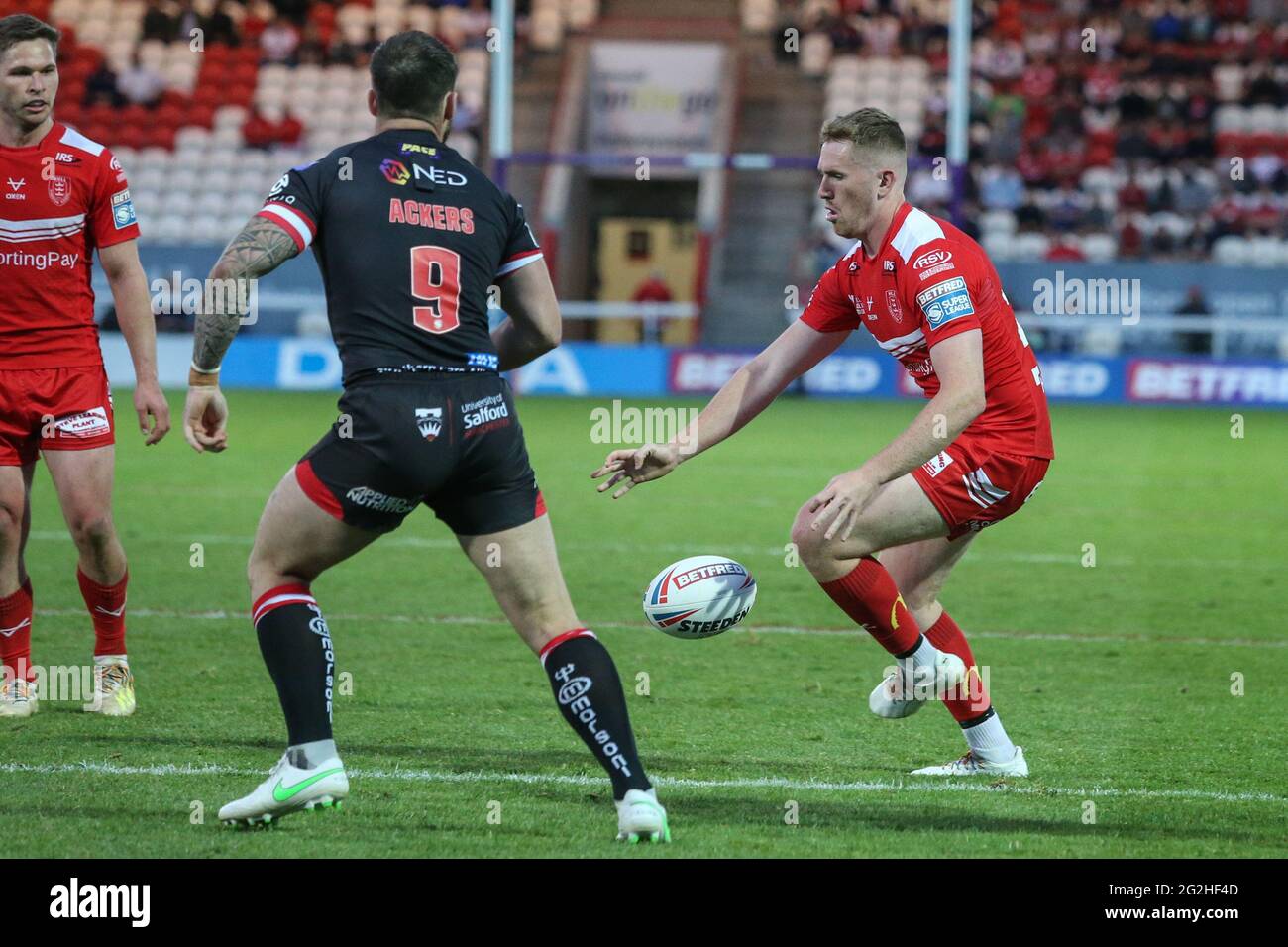 Rowan Milnes (25) of Hull KR puts a kick through Stock Photo - Alamy