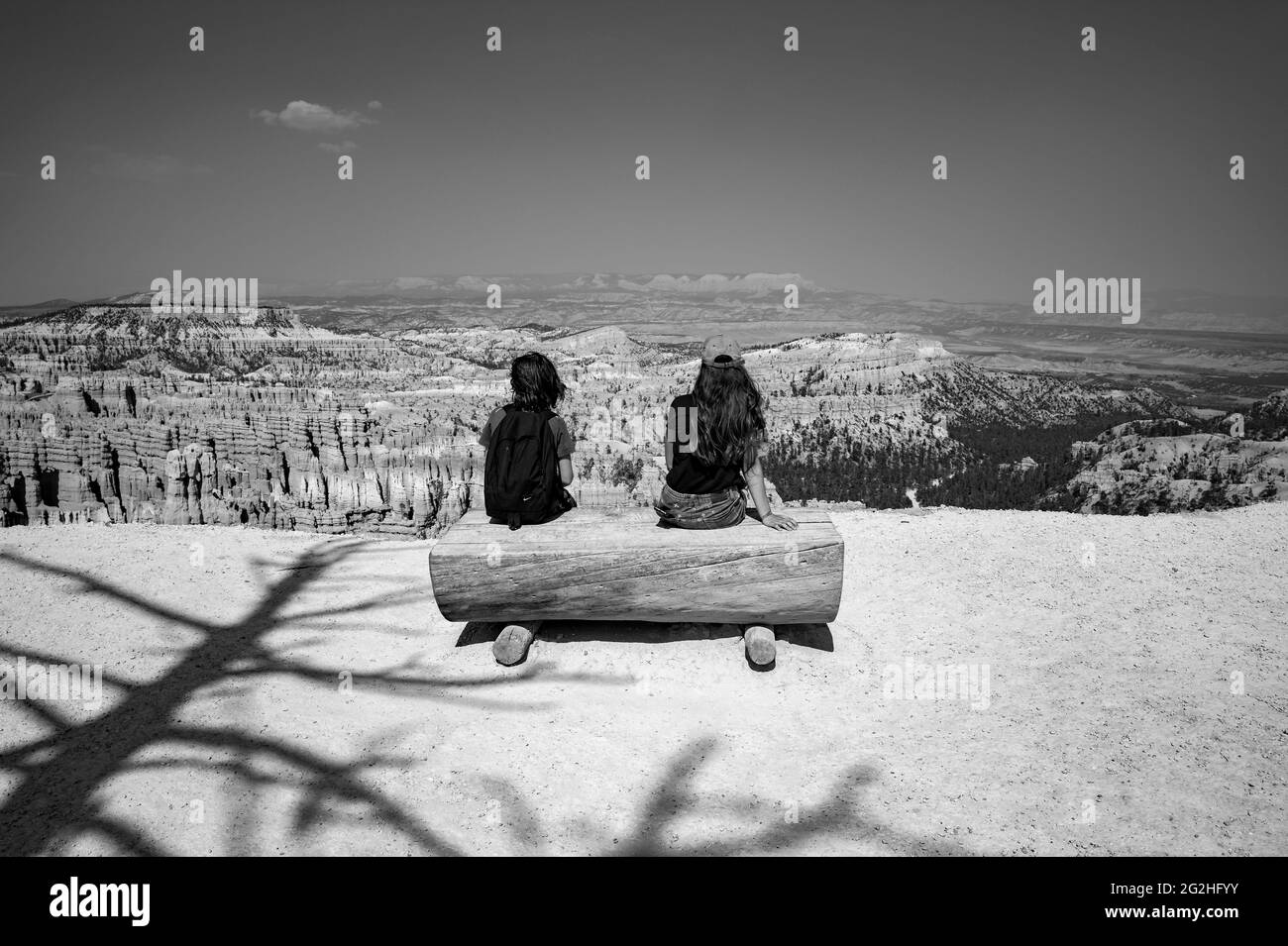 Boy and girl having a seat and watching from Inspiration Point - an ...