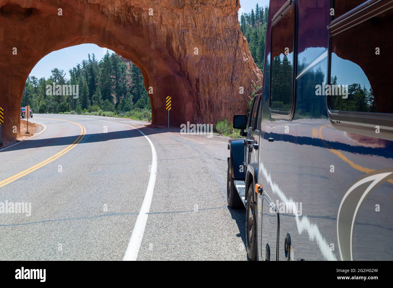 Jeep and blue Caravan parking in Front of famous Red Canyon Arch ...