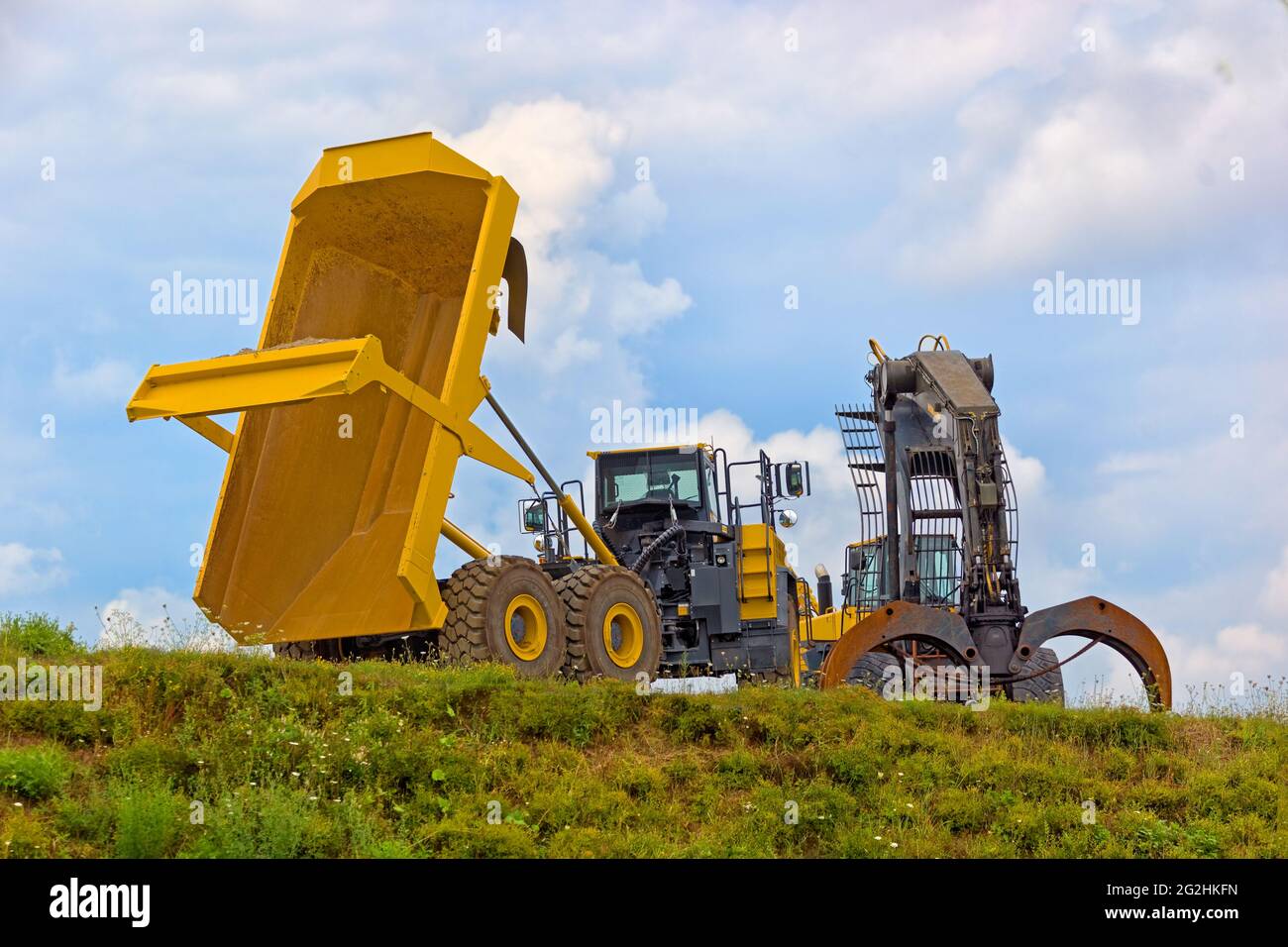 Truck tipper with grab excavator stand on an embankment, Hanover ...