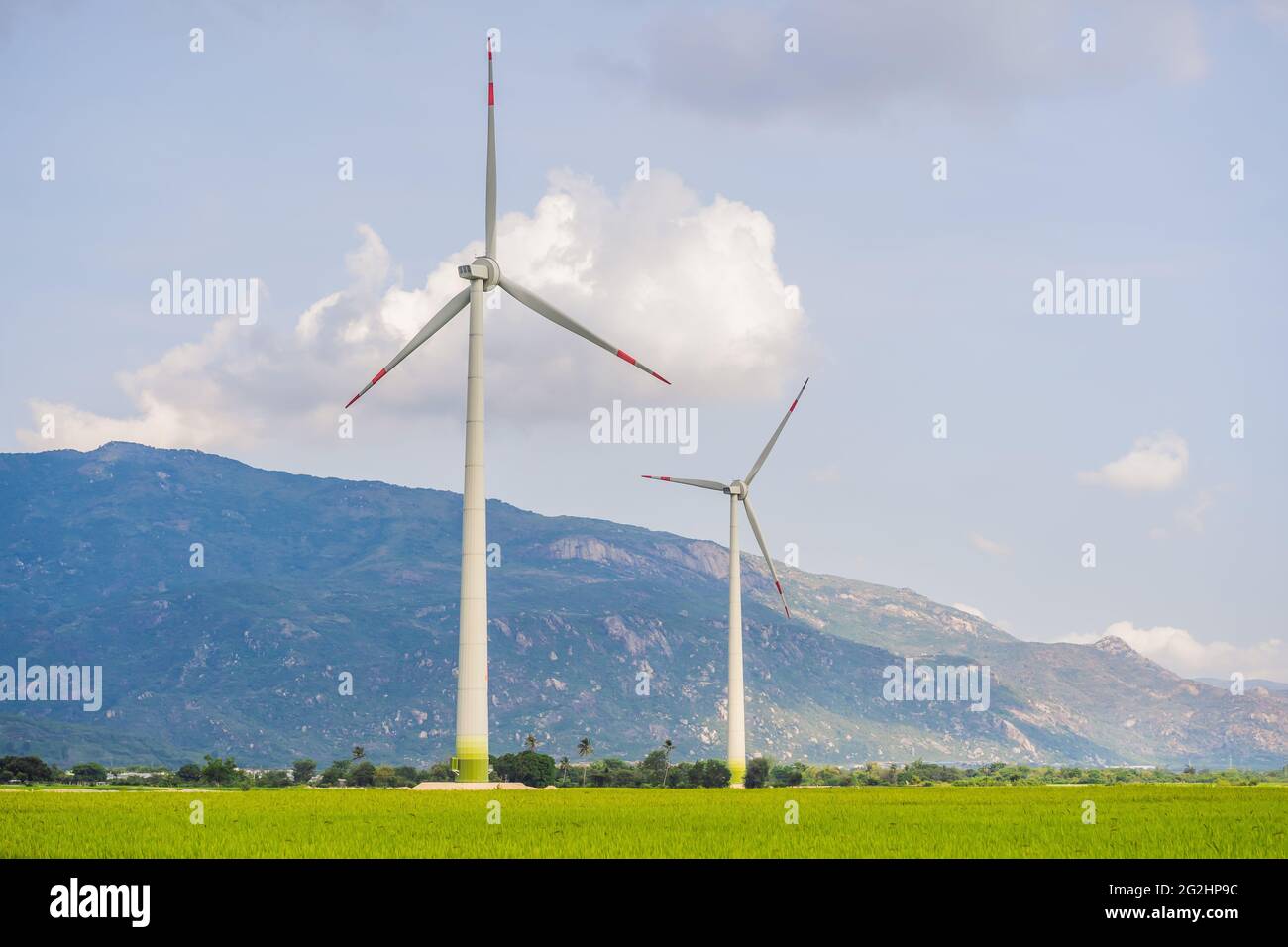 Wind power plant. green meadow with Wind turbines generating ...