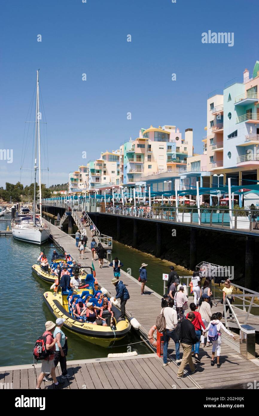 Albufeira, marina, excursion boats, tourists, colorful houses, cafes ...