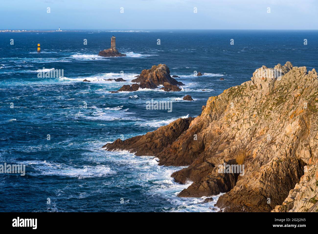 Rocky coast of the Pointe du Raz, lighthouse La Vieille in the sea, in ...