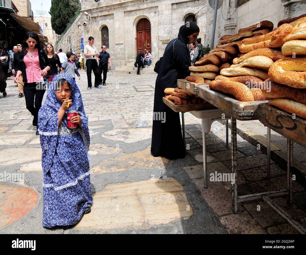 A young Palestinian girl drinking Crystal Cola in the Muslim quarter of ...