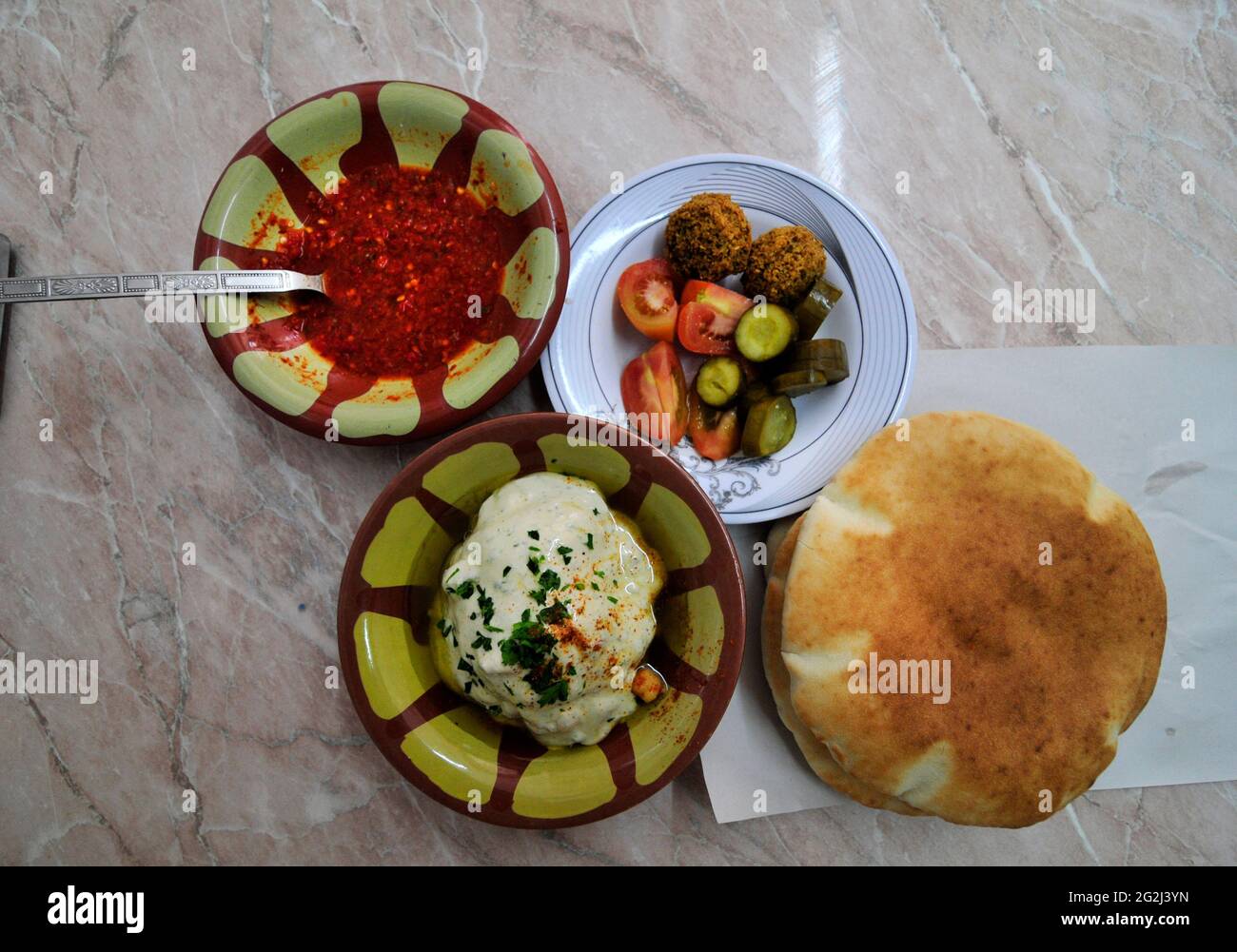 Hummus served with pita bread and veggies. Spicy sauce can be added to ...