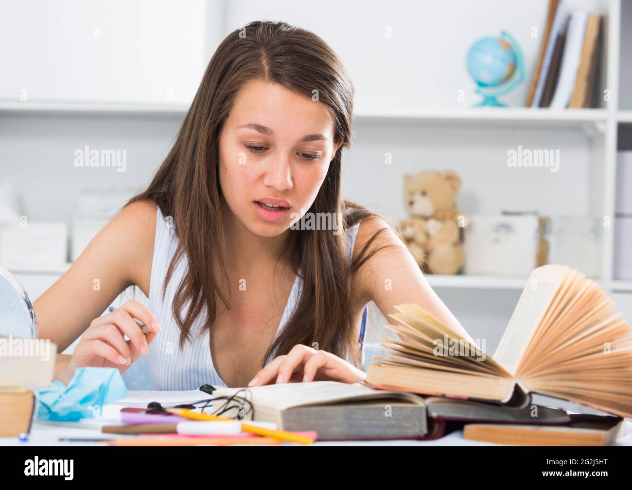 Teenage girl is writing a review of novel Stock Photo - Alamy