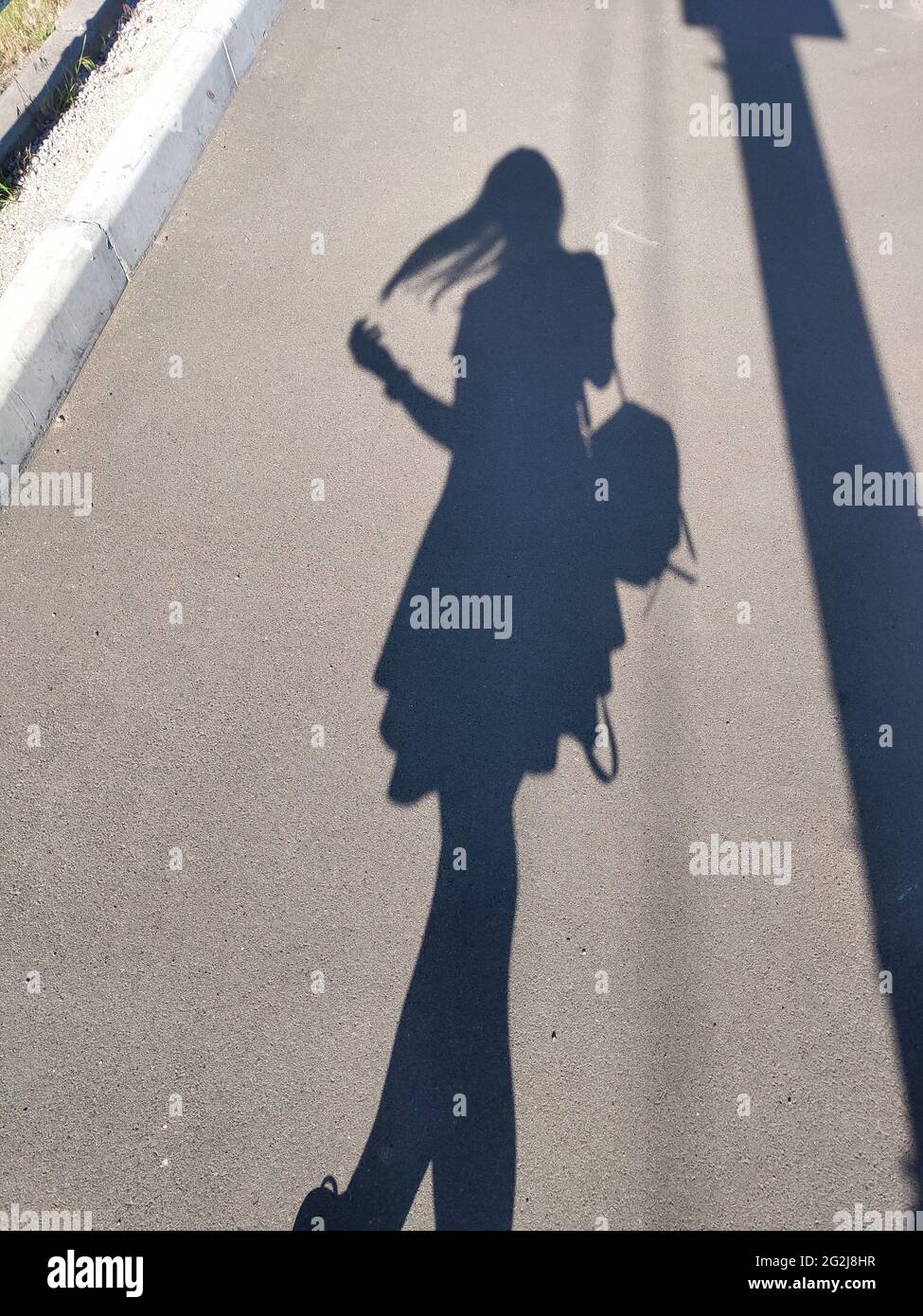 Shadow of the woman in dress on the street Stock Photo - Alamy